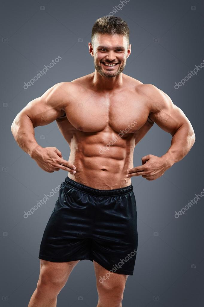 Bodybuilder man pointing at abs Stock Photo by ©kegfire 97586450