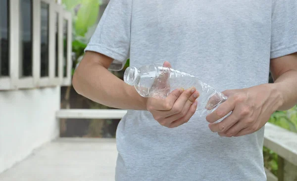 man squeezing plastic bottle. concept to reduce the amount of storage ...