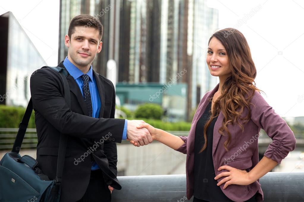 Partners clients deal handshake handsome man woman business finance ...