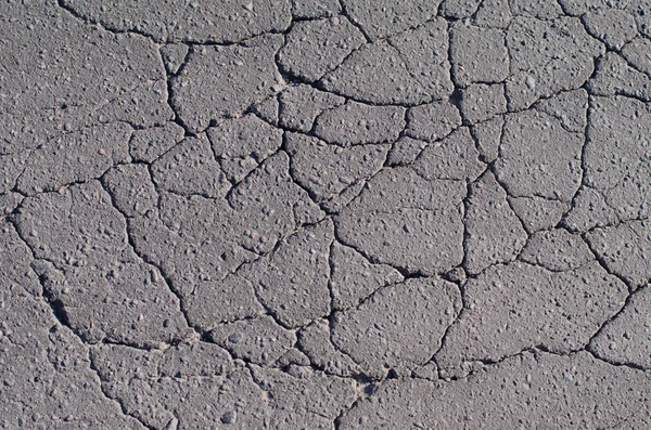 Texture of road surface made of asphalt concrete with a net of cracks ...