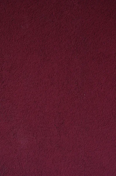 Background of a deep red stucco coated and painted exterior, rough cast ...