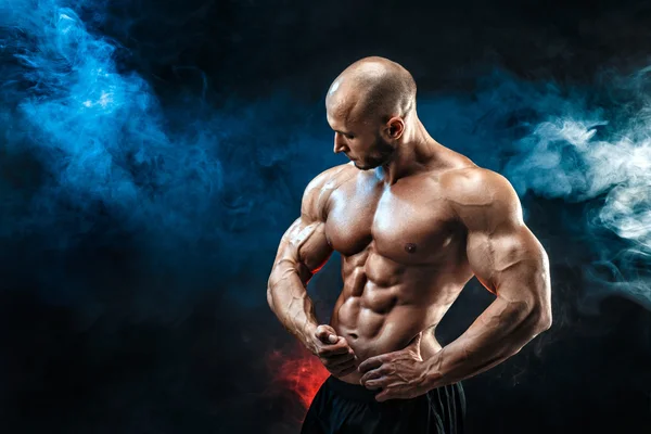 Strong bodybuilder man with perfect abs, shoulders,biceps, triceps ...