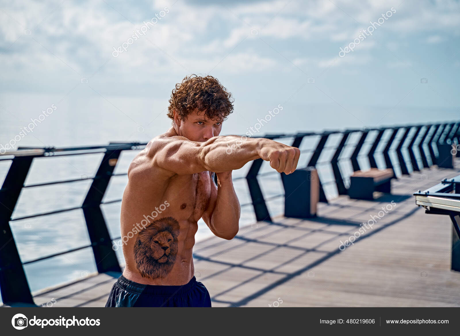 Muscular young man athlete standing and practicing shadow boxing ...
