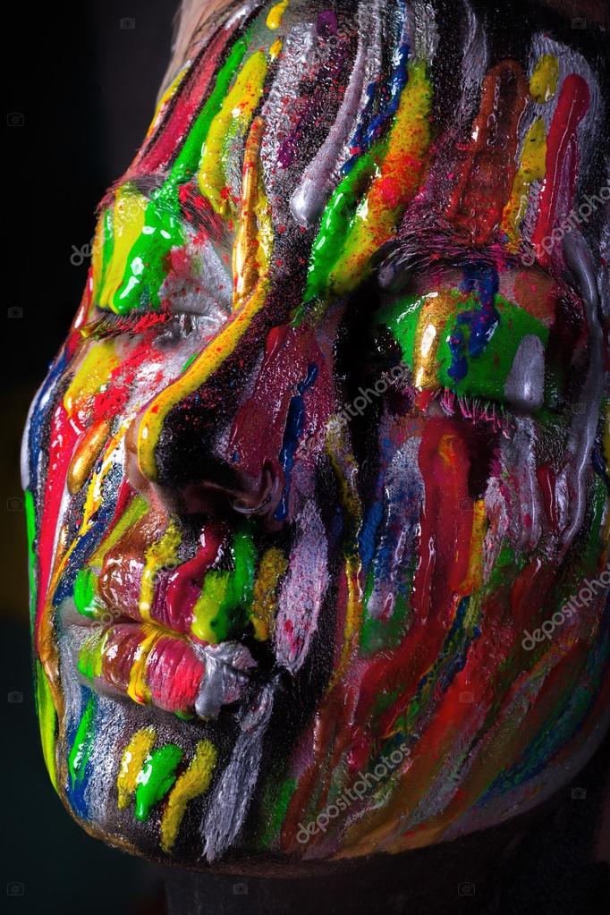 Girl with colored face painted. Art beauty image. Stock Photo by ...