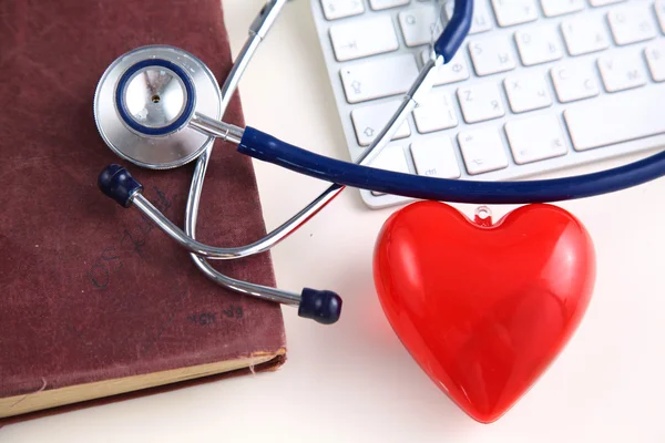 Medical stethoscope with old books and laptop on a table - Stock Image ...
