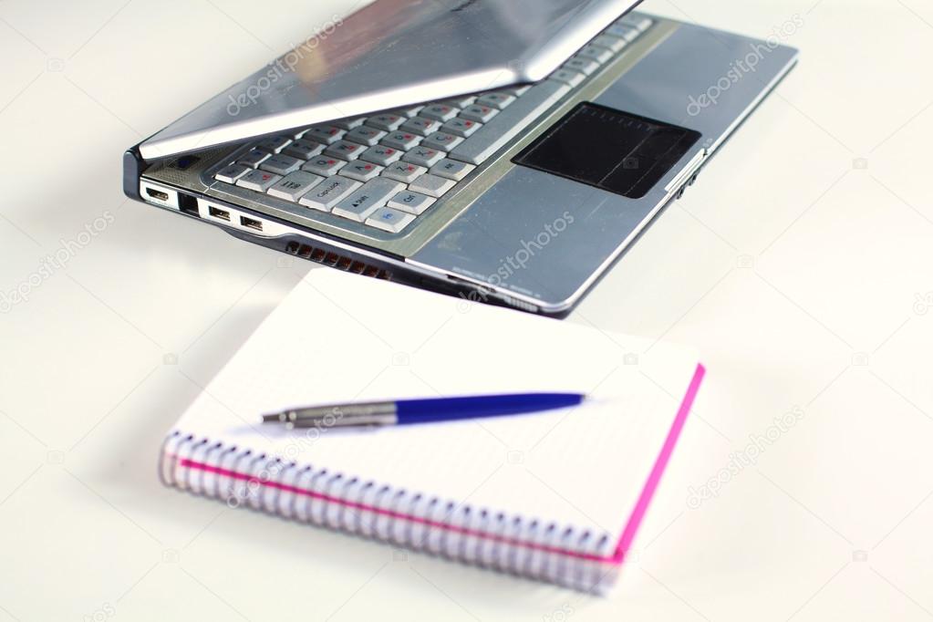 Office table with blank notepad and laptop Stock Photo by ©lenecnikolai ...