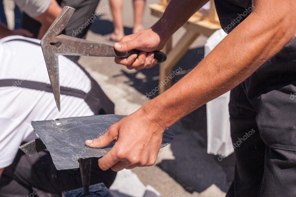 Worker produces roofing slate using a slate hammer Stock Photo by ...