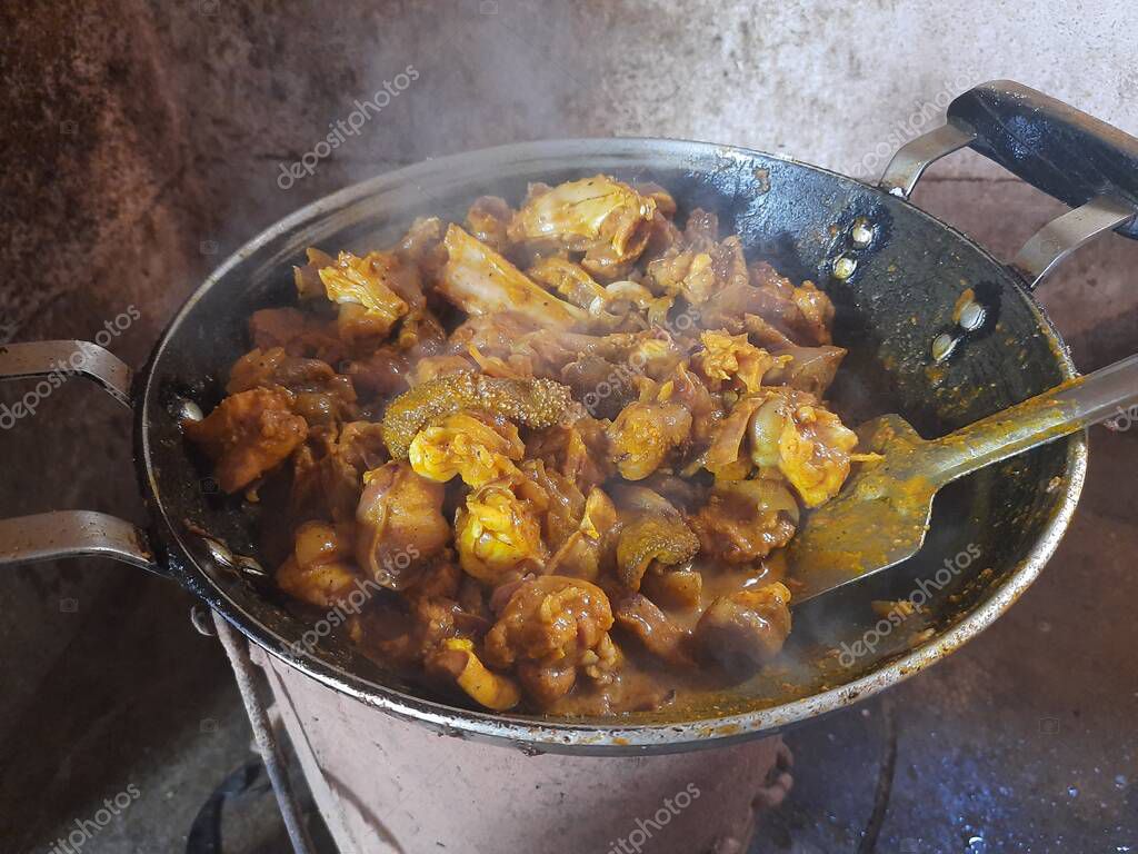 Cocinar la carne de cabra en una sartén en la estufa de carbón en la ...
