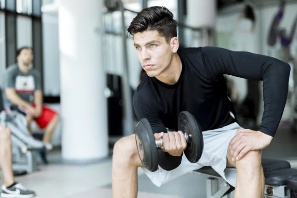 Young man training in a gym - Stock Image - Everypixel