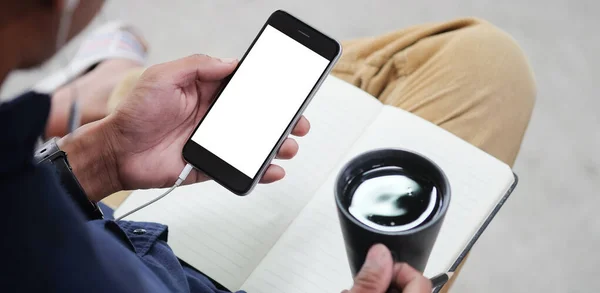 Mock up smartphone of hand holding black mobile phone with blank white ...