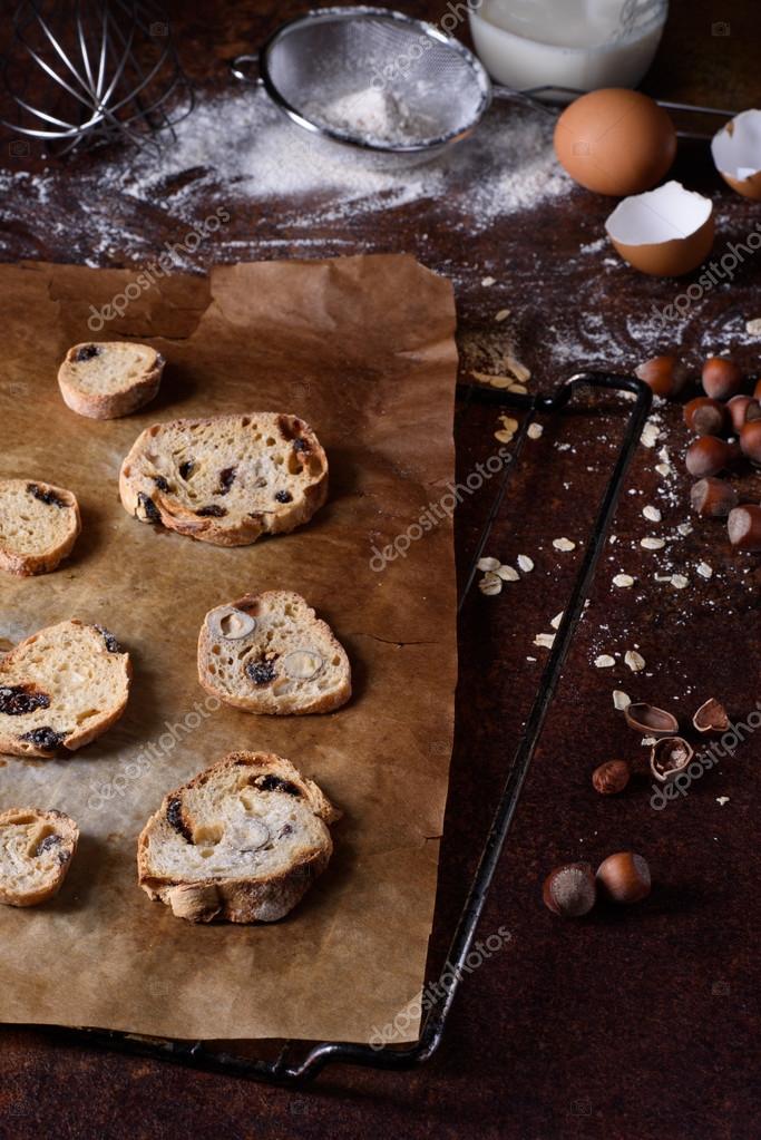 Baked bread rusks with raisins and nuts, cooking ingredients over ...