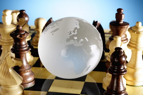 Chess pieces and globe — Stock Photo © infocuss #82693286