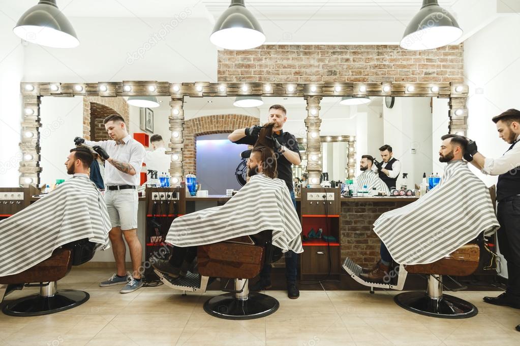Barbers doing haircuts for clients Stock Photo by ©VelesStudio 115666018