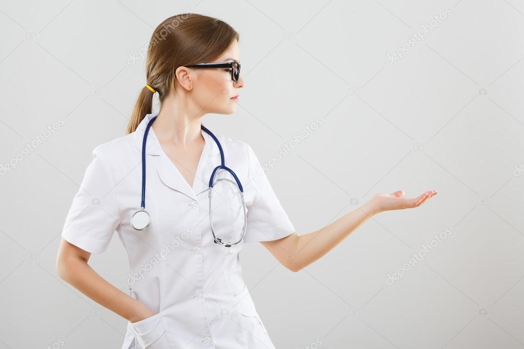 Pretty nurse at studio background Stock Photo by ©VelesStudio 124249590