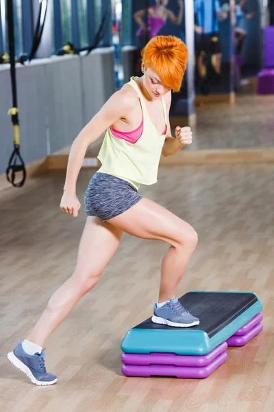 Woman performing exercise in gym - Stock Image - Everypixel