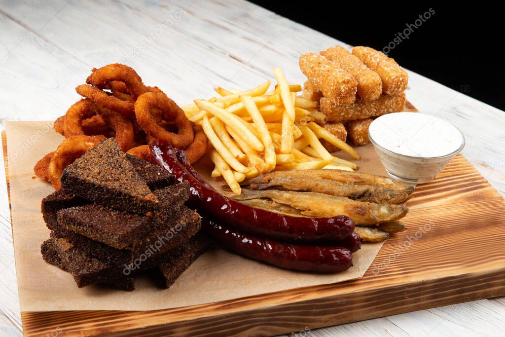 conjunto de bocadillos de cerveza. Embutidos fritos, papas fritas ...