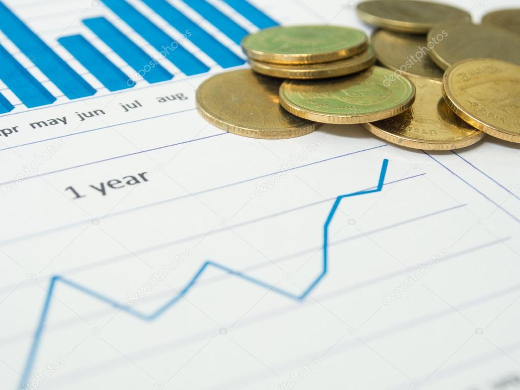 Gold coins and financial reports Stock Photo by ©utah778 80934022