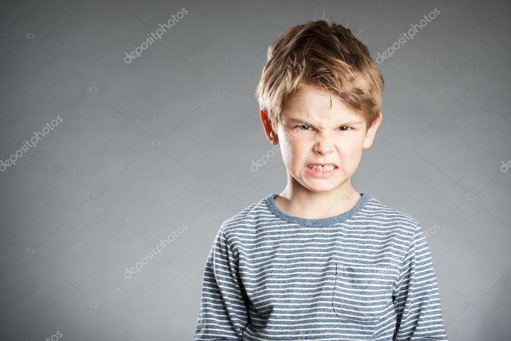 Portrait of boy, emotion, angry, grey background Stock Photo by ...