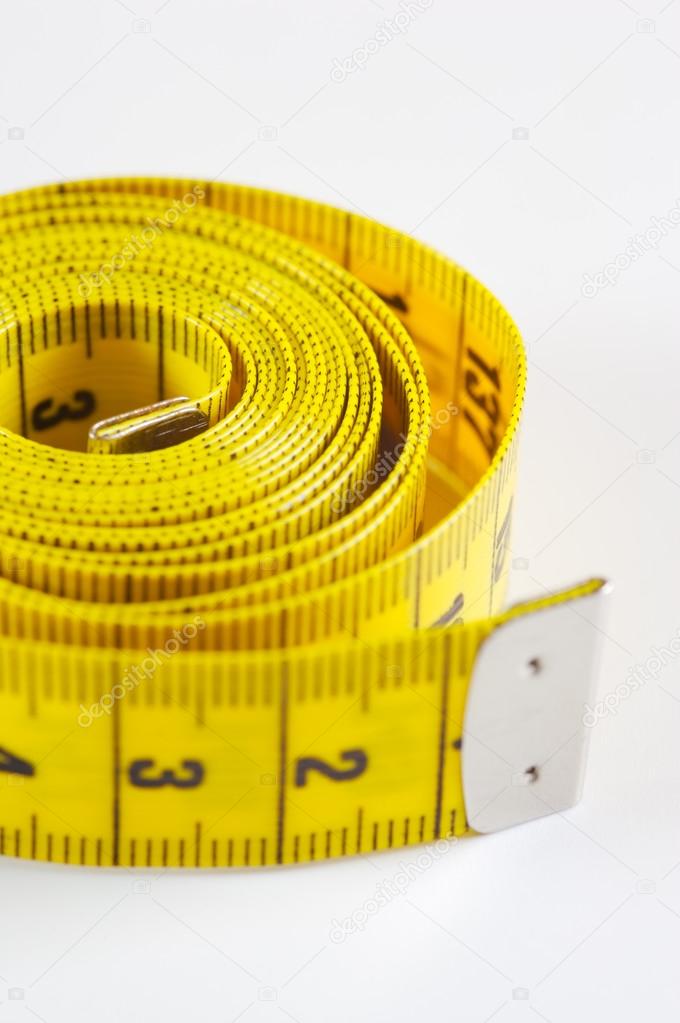 Measuring tape with centimeters rolled up against white background ...