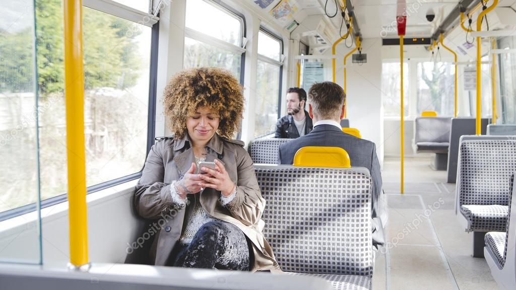 Texting on the train Stock Photo by ©DGLimages 121058602