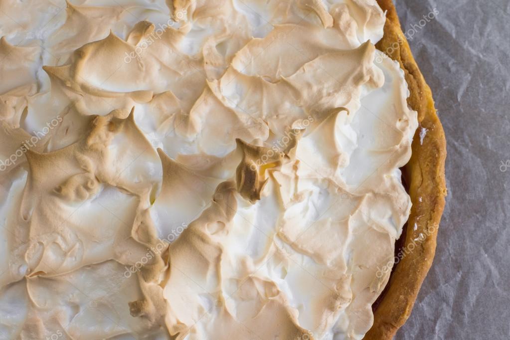 Detailed view on Meringue cake with strawberry jam on baking pap ...