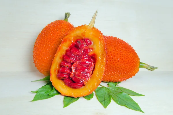 Gac fruit, typical of orange-colored plant foods in Asia isolate Stock ...