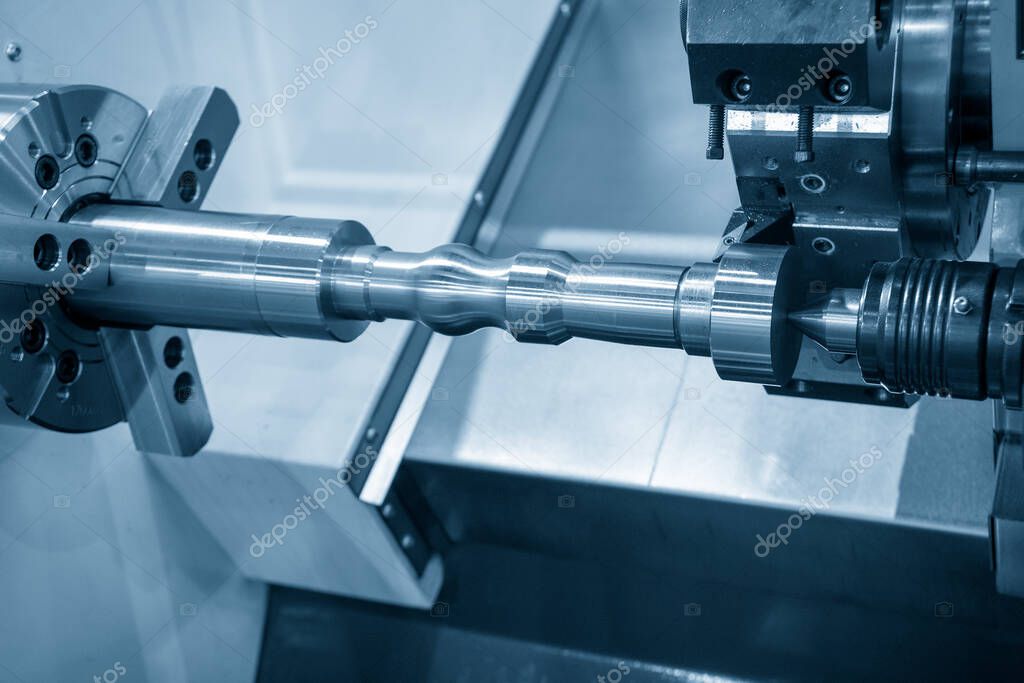 La máquina de torno CNC que corta las piezas del eje de metal. El procesamiento de mecanizado de ...