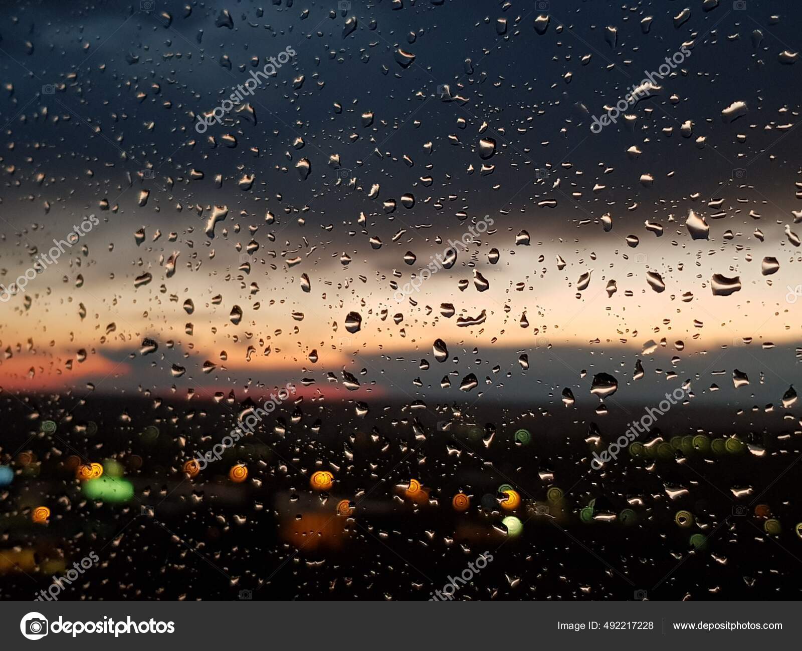 Raindrops On Window In City