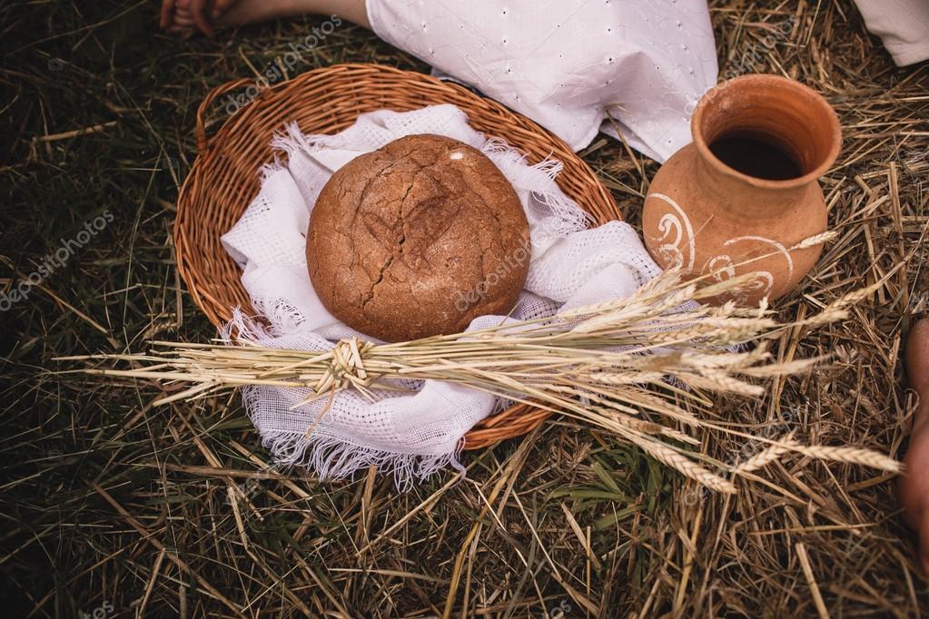 Old jug and homemade bread with grains on the nature — Stock Photo ...