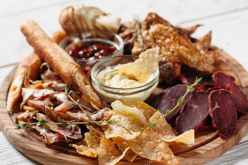 Beer snacks plate. Meat and chips Stock Photo by ©golubovy 110512558