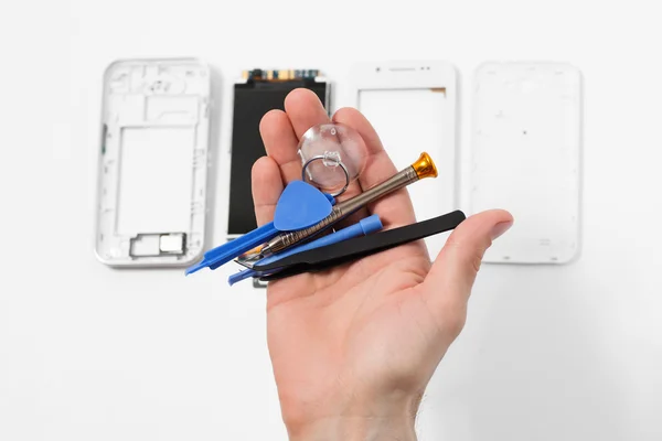 Disassembly tools and disassembled phone - Stock Image - Everypixel