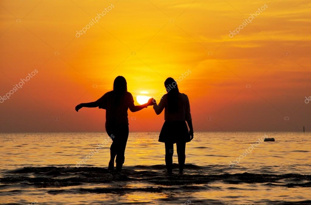 Two Best Friends Holding Hands In The Sunset
