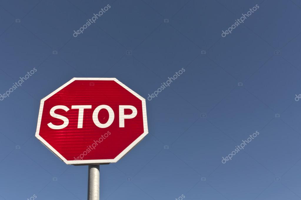 Red stop sign and blue sky. — Stock Photo © pavelalexeev #103938622