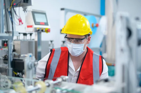 Quality control (QC) engineer monitoring and checking machine system in ...