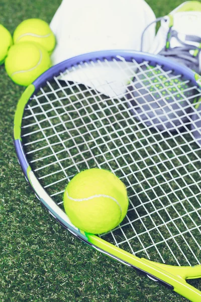 Two tennis rackets and ball on green background, top view Stock Photo ...