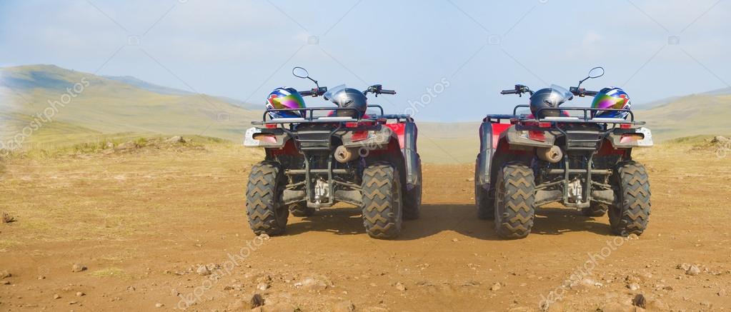 Quad bikes with sport helmets Stock Photo by ©borjomi88 113204178