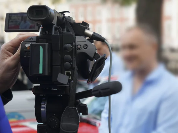 video operator in work. videographer is doing an interview. cameramam ...