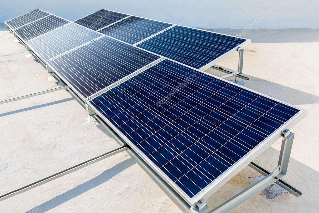 Solar panels standing on a rooftop Stock Photo by ©mandritoiu 82405520