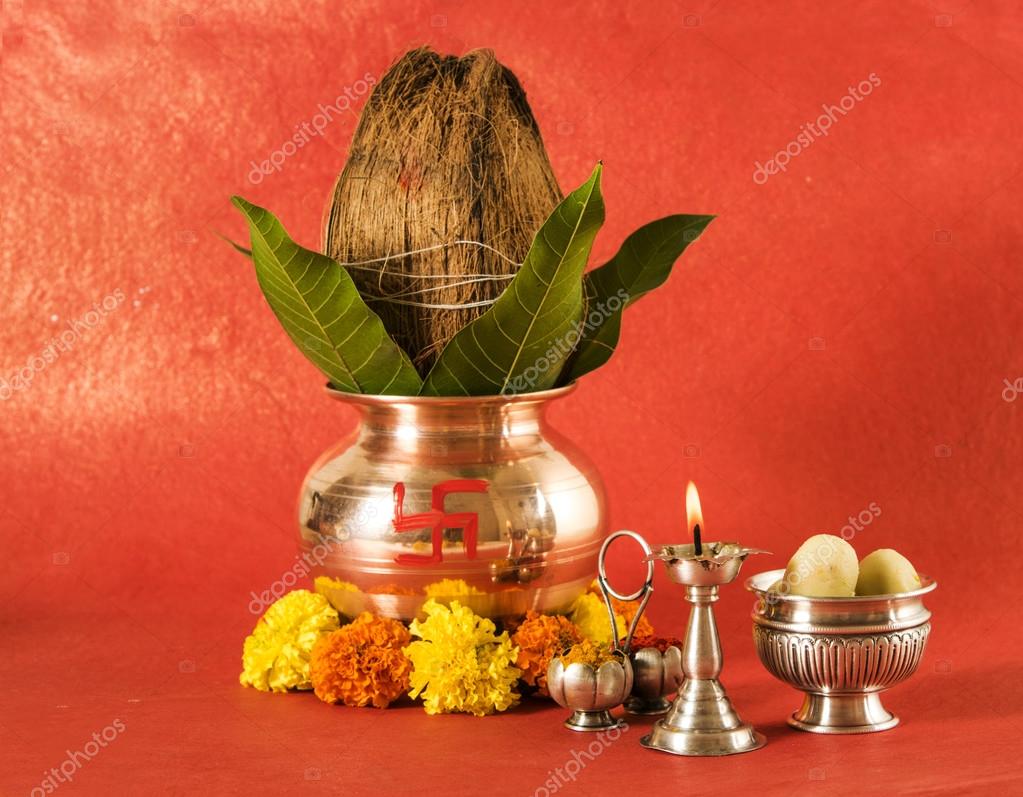 Hindu puja elements, kalash with coconut and mango leaves,diya, haldi ...