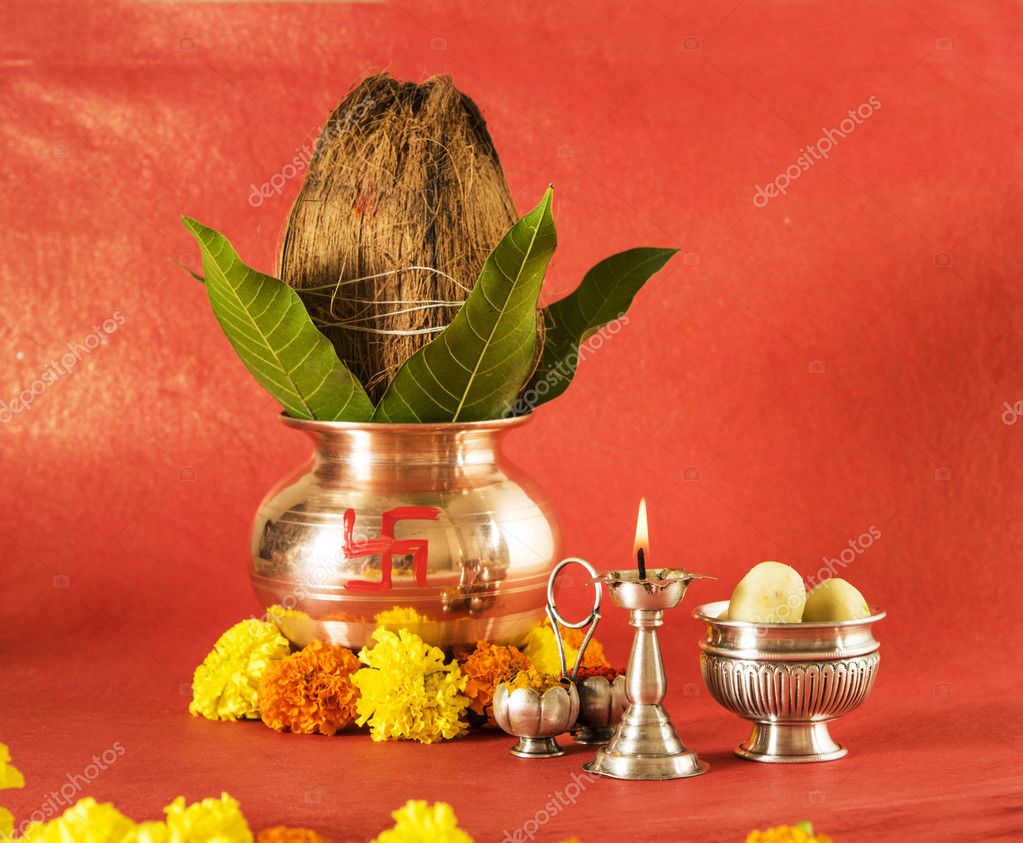 Hindu puja elements, kalash with coconut and mango leaves,diya, haldi ...