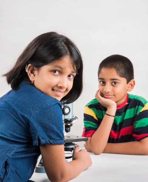 Indian smart girl and boy or school kids holding gold medal and trophy ...