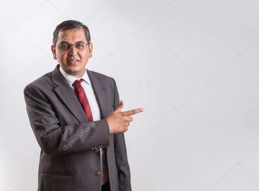 Indian Businessman isolated over white background presenting copy space ...