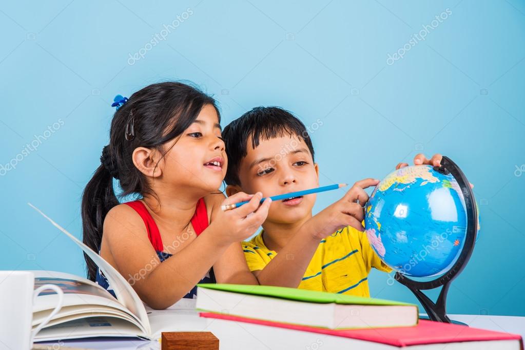 Indian boy and girl studying with globe on study table, asian kids ...