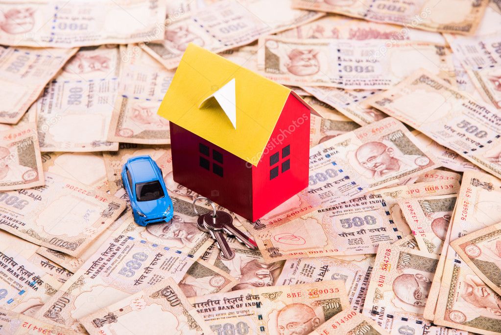 Buying home and car concept, indian currency notes, model home, keys ...