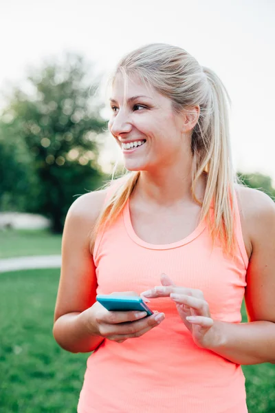 Sports woman using mobile phone - Stock Image - Everypixel