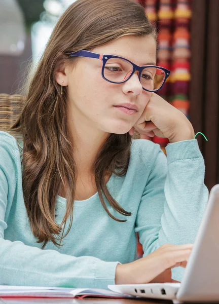 Pretty student girl doing homework at home with a laptop Stock Photo by ...