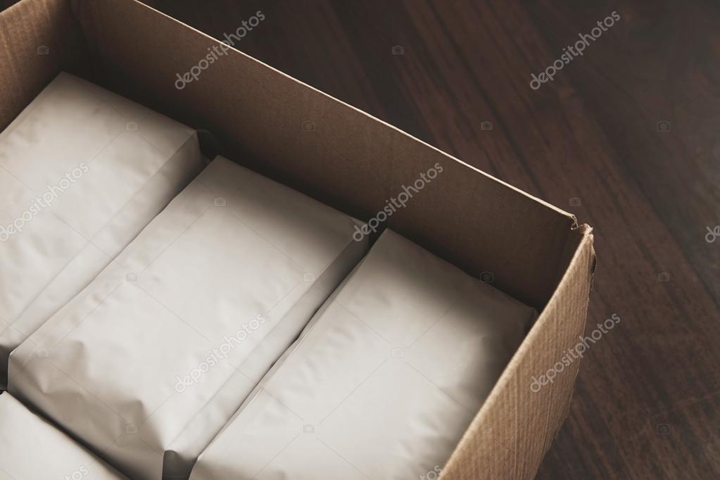 Opened big carton box full of blank hermetic white packages — Stock ...