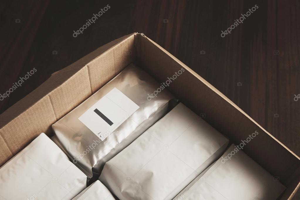 Opened big carton box full of blank hermetic white packages Stock Photo ...