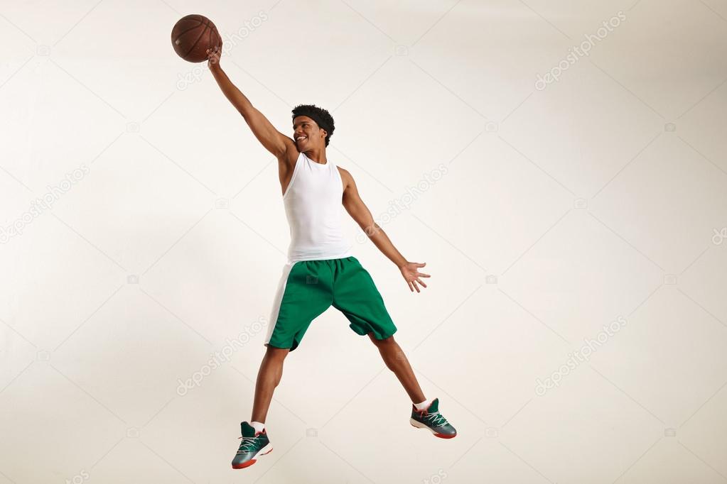 Smiling black man reaching high for a basketball — Stock Photo ...