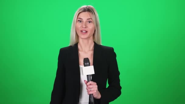 Female reporter in suit looks into the camera and speaks into a ...